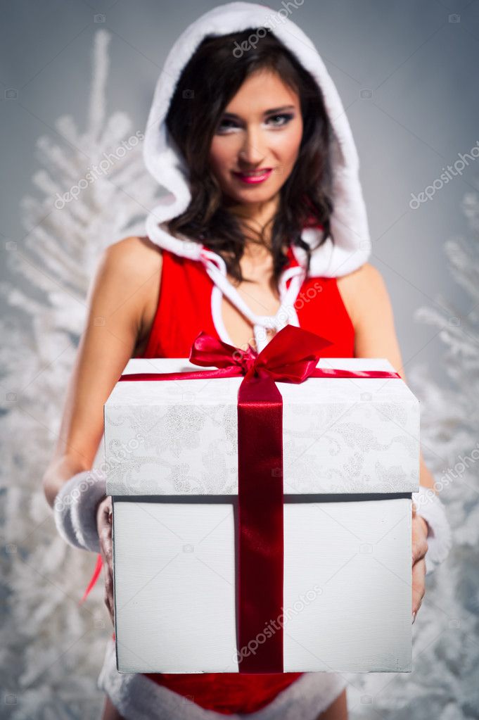 Beautiful santa woman with a gift box Stock Photo by ©amoklv 7515551