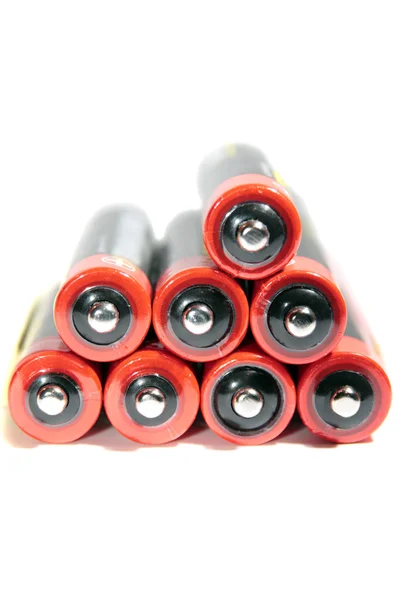 Black and red batteries in a row on white — Stock Photo © morrbyte #7302189