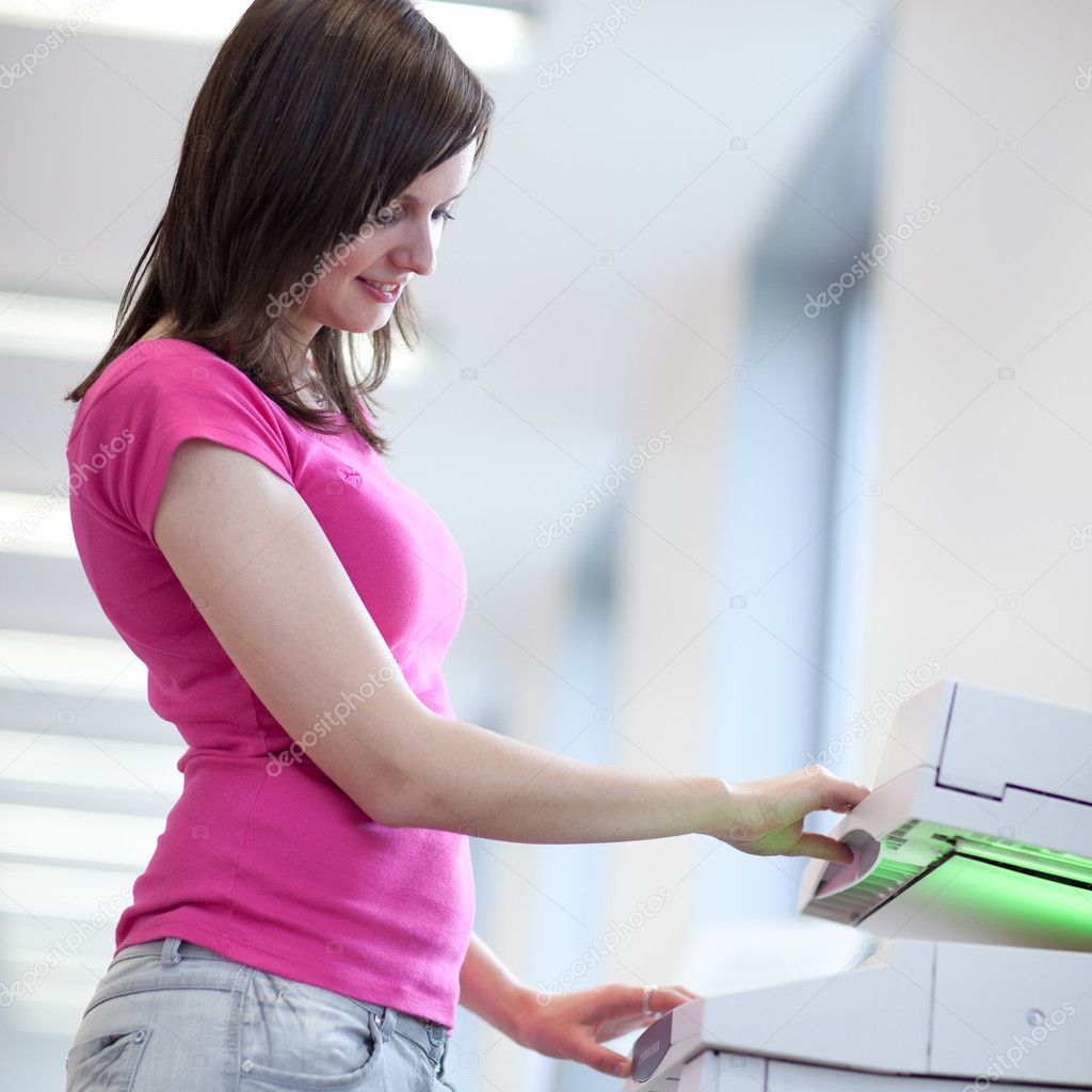 Pretty young woman using a copy machine Stock Photo by ©lightpoet 7417594