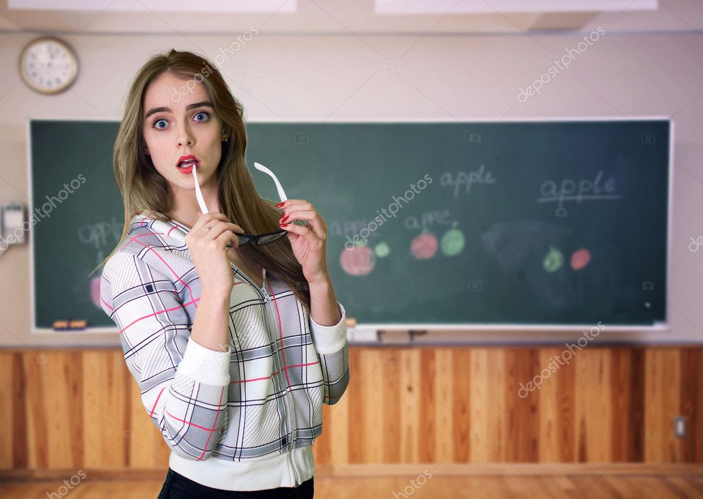 Pretty amazed young teacher in front of a blackboard. — Stock Photo ...