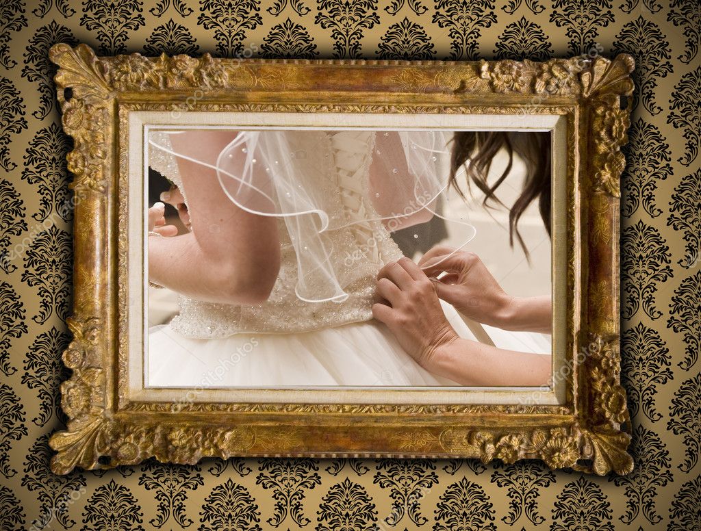 Wedding image in antique gilded frame on vintage damask style wa ...