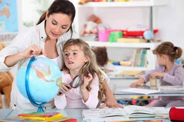 Teacher giving a geography lesson - Stock Image - Everypixel