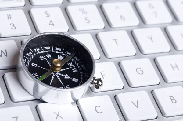 Computer keyboard and retro compass — Stock Photo © merznatalia #18372375